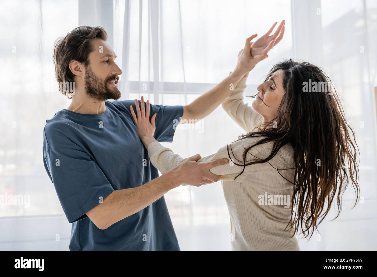 Angry man beating worried girlfriend during conflict at home,stock ...