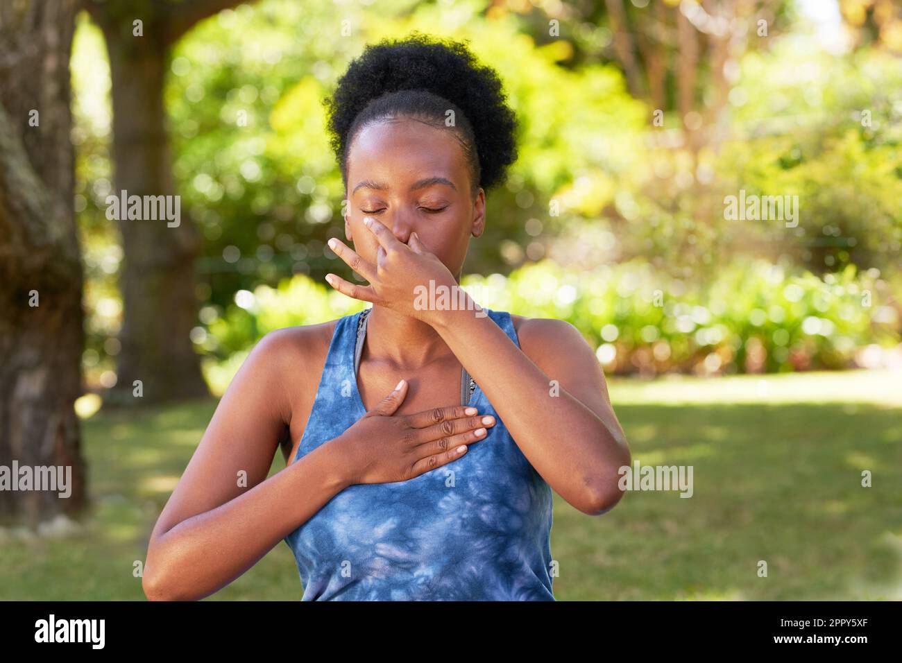 Young Black woman practices alternate nostril breathing sitting ...