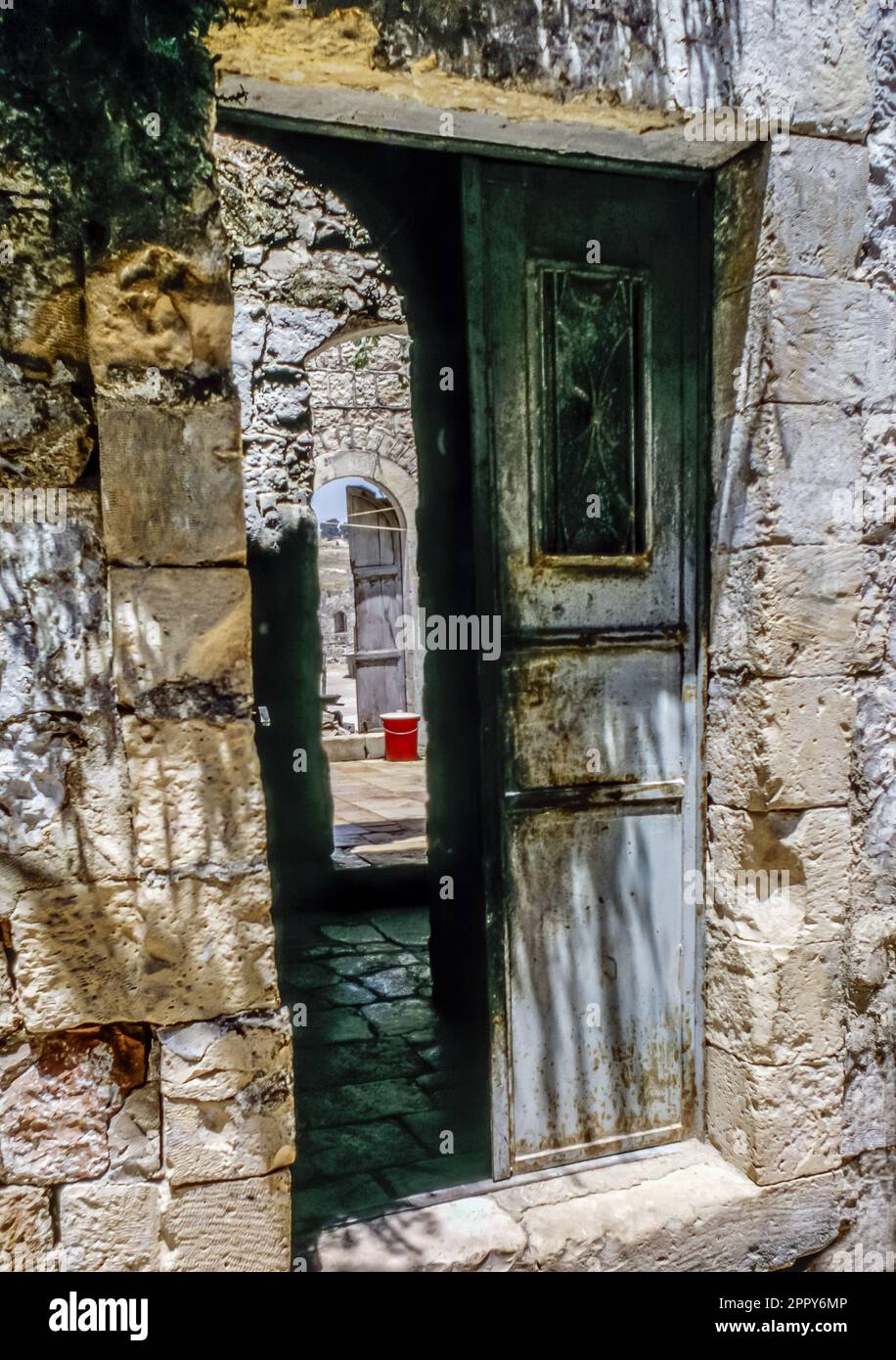Mulitple old doorways set in stone walls and looking through to red ...