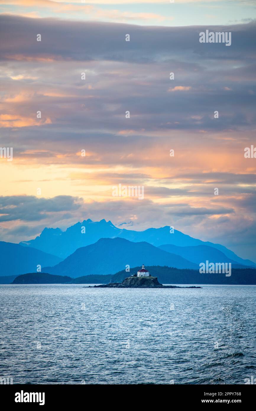 Eldred Rock Lighthouse at sunset with dramatic mountain range in ...