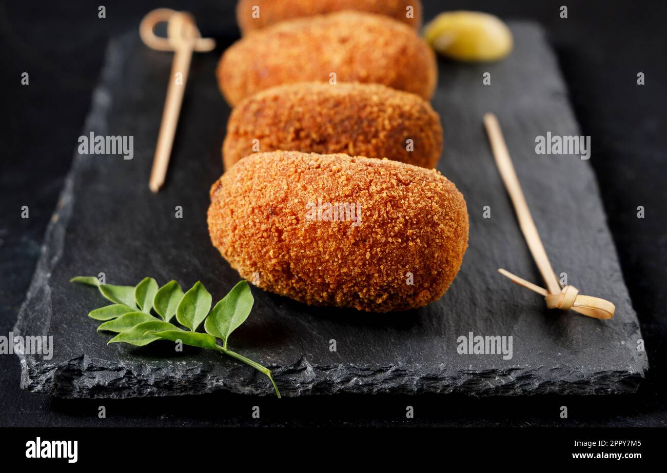 Close-up of gourmet-style ham croquettes with a black background Stock ...