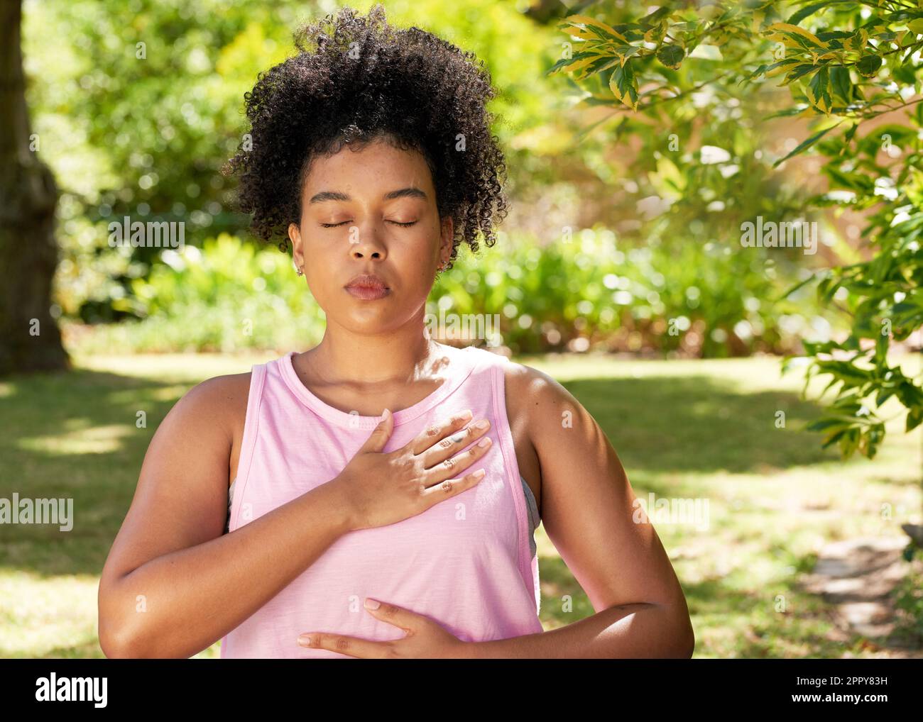 Young mutli-ethnic woman practices deep belly breathing, meditation in ...