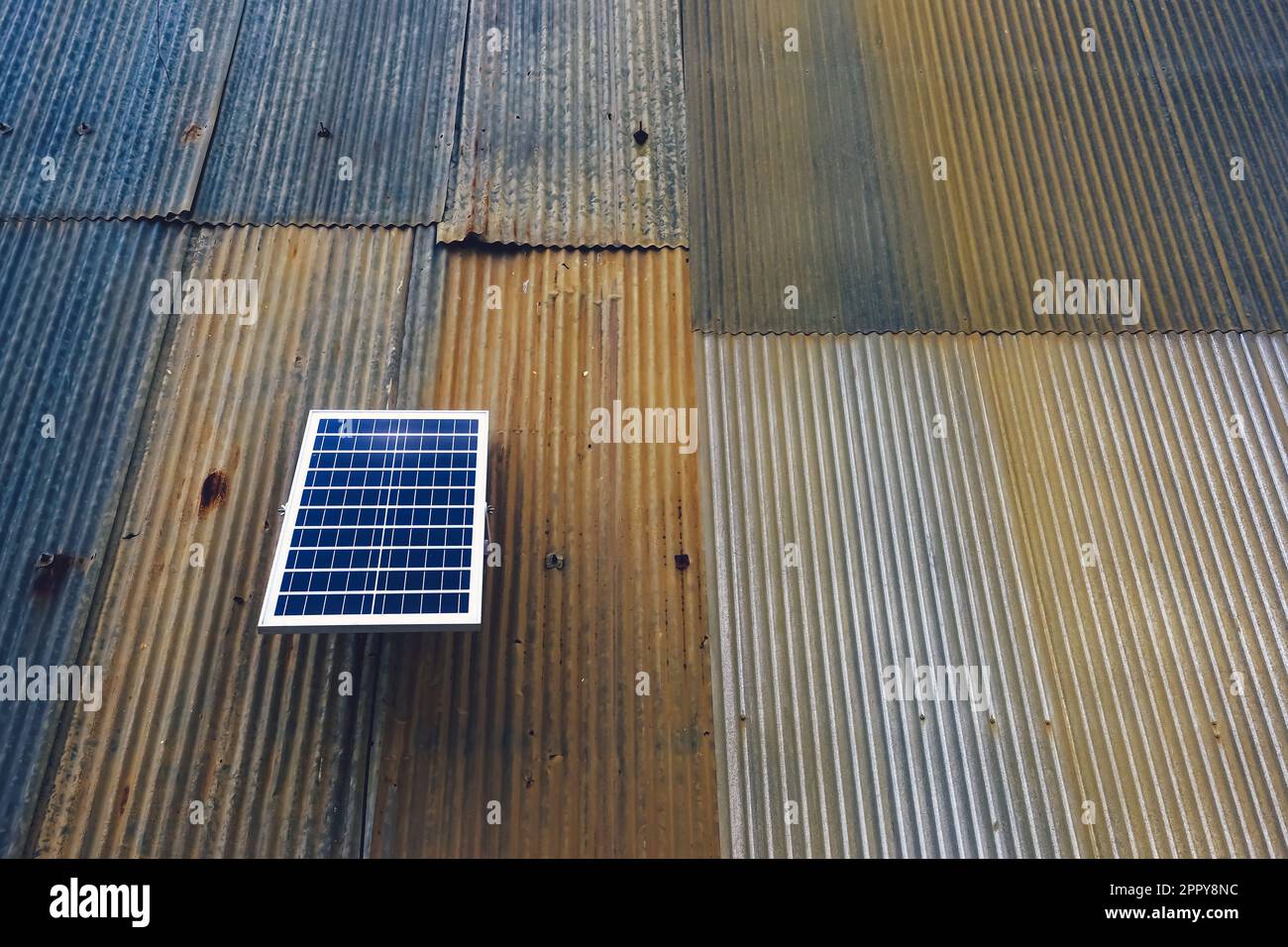 Solar panel attached on old zinc wall. Electric solar panel on the ...