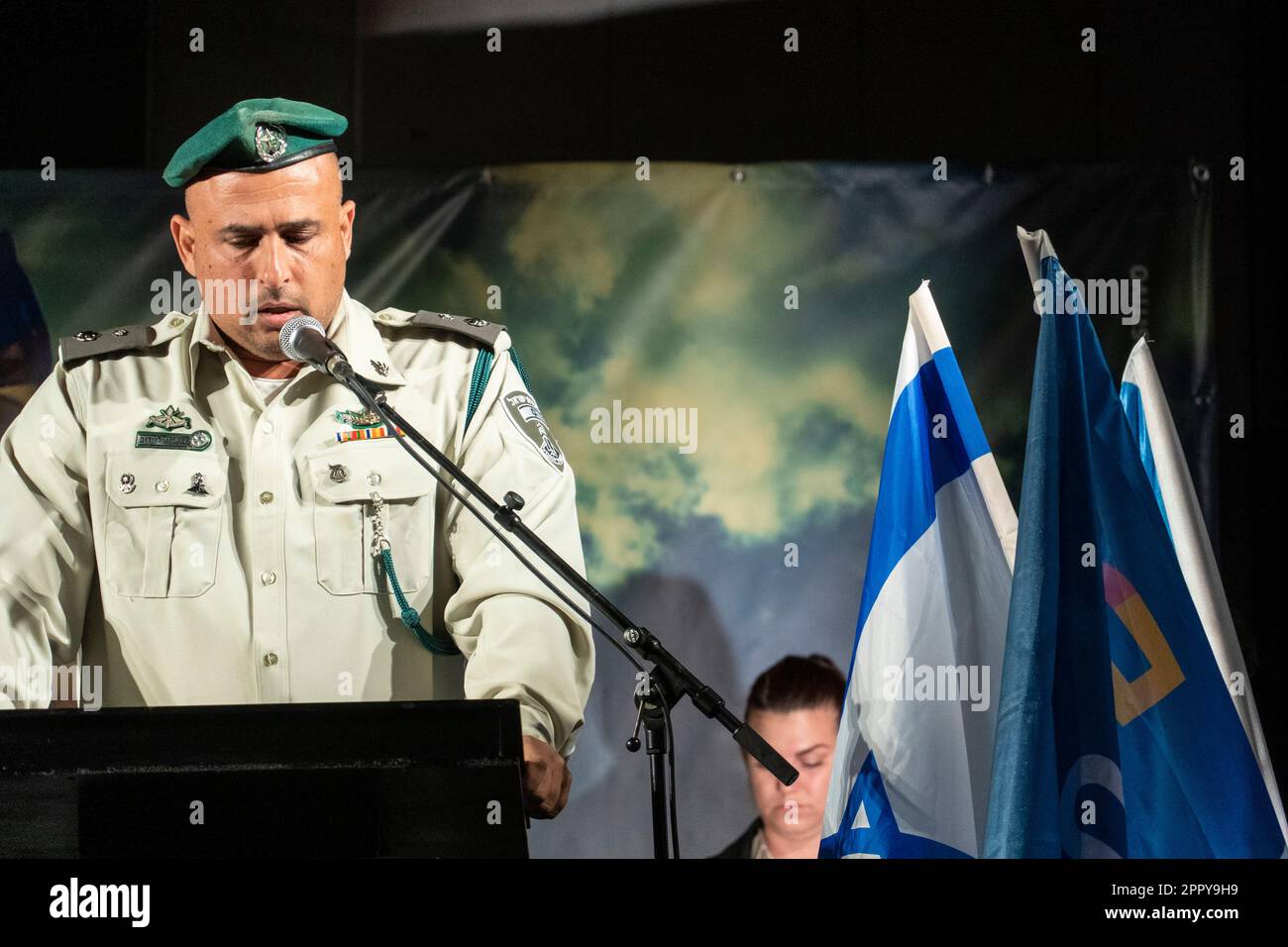 Harish, Israel. A border police officer speaks, with a large Israeli ...