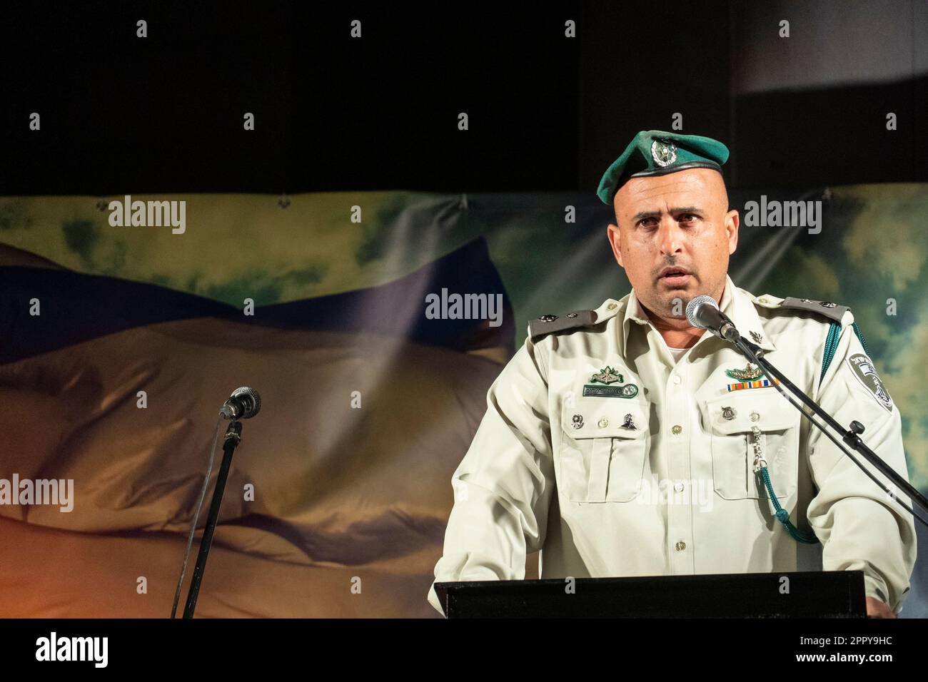 Harish, Israel. A border police officer speaks, with a large Israeli ...