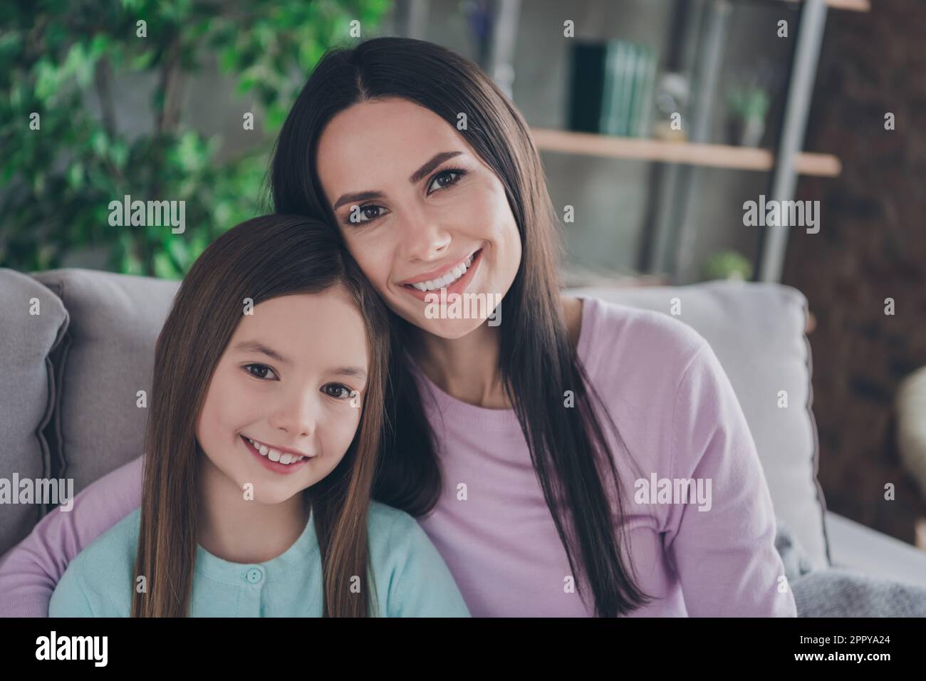 Photo Of Two Pretty Girls Mother And Daughter Sitting Home Spend Time