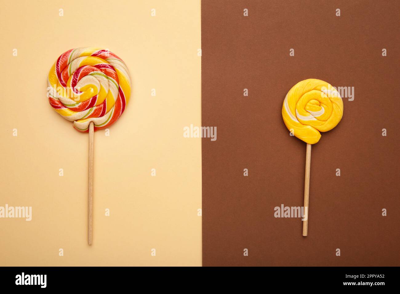 Two colorful sweet lollipops for children on brown. Top view Stock ...