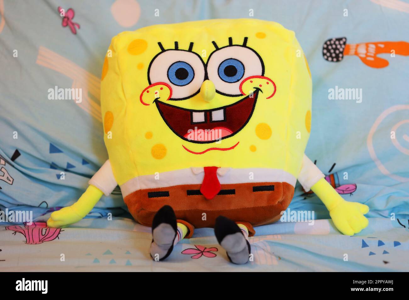 Russia Vyborg 04.04.2023 Soft toy SpongeBob sits on a pillow Stock ...
