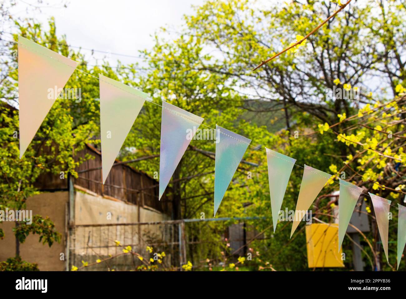 The colorful triangle flags hanging on a rope Stock Photo - Alamy