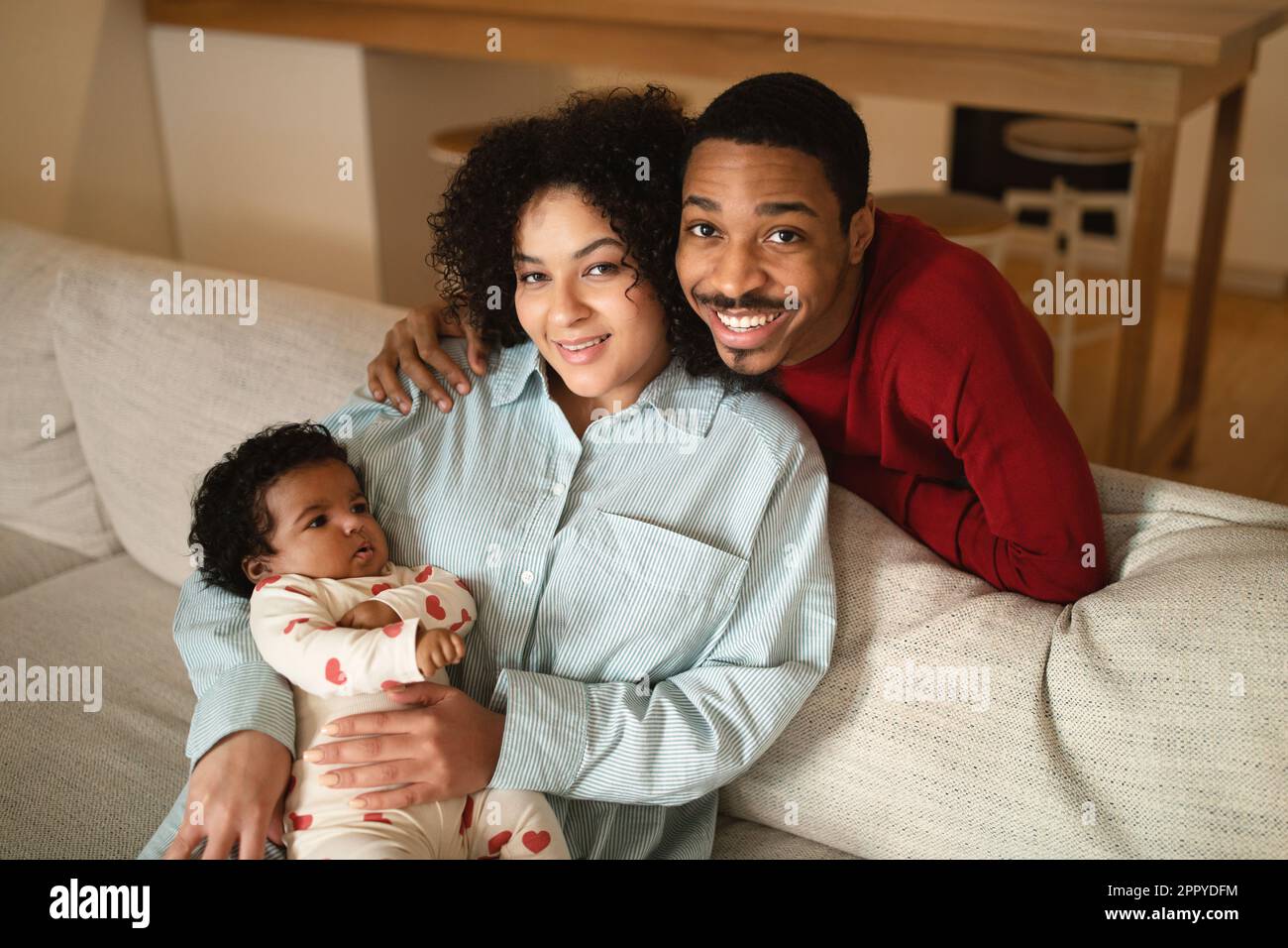 Portrait of happy multicultural family, mother, father and little baby ...