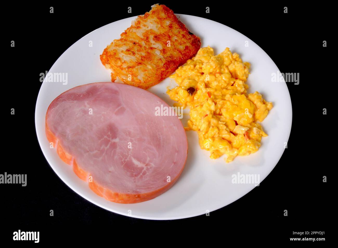 Breakfast plate of ham steak hash brown potatos and mexican omlette ...