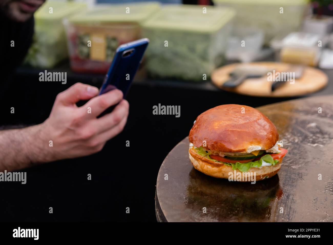 Man hands taking burger close hi-res stock photography and images - Alamy