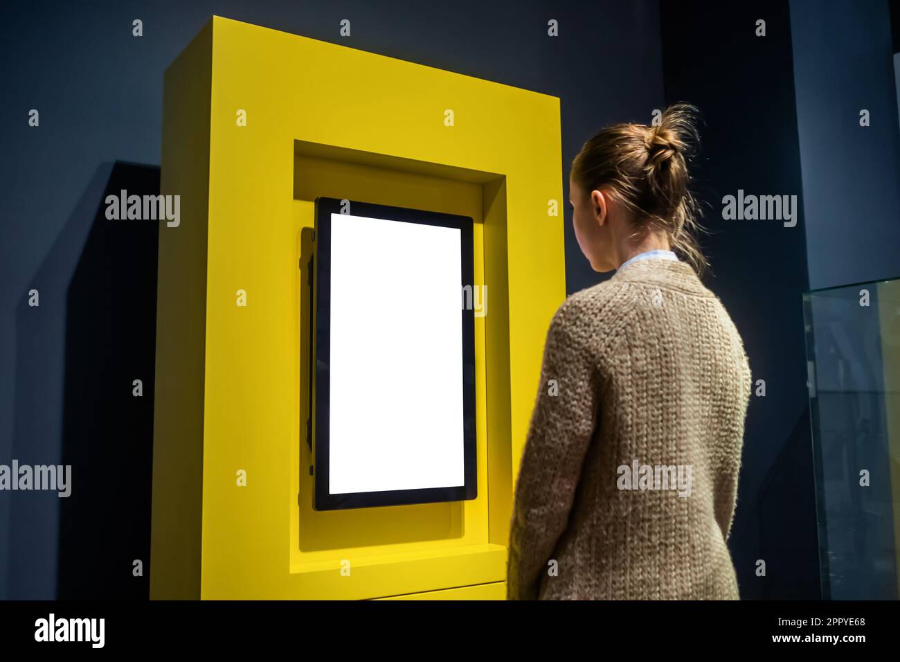 Woman looking at blank white display wall at exhibition - white screen ...