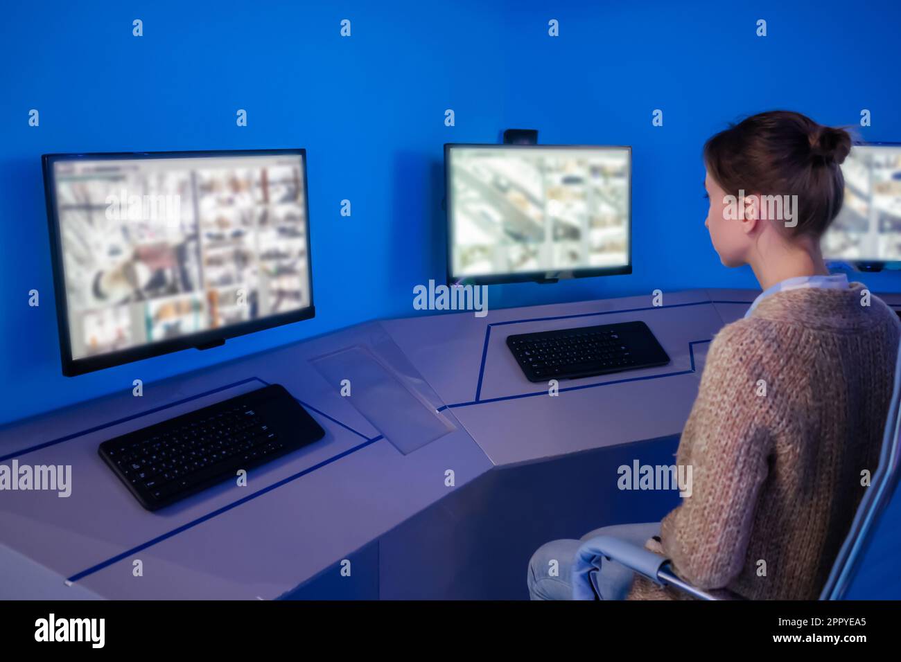Woman security guard looking at modern cctv camera monitors Stock Photo ...