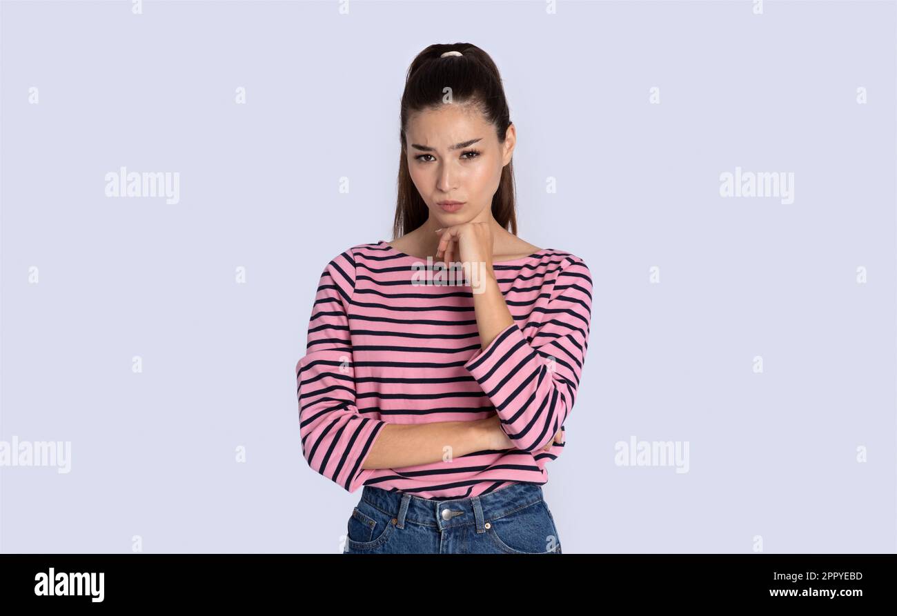 Young woman looking sceptical hi-res stock photography and images - Alamy