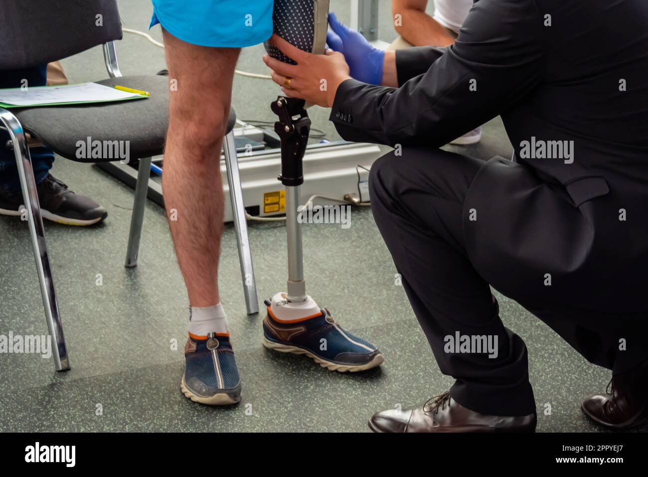 Physiotherapist helping young man with prosthetic leg Stock Photo - Alamy