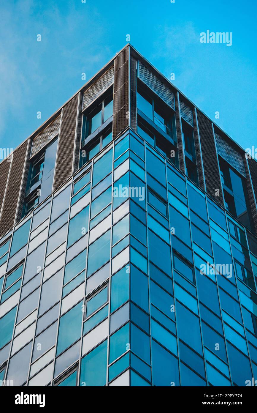 Tower block office building windows reflective glass blue sky tall ...