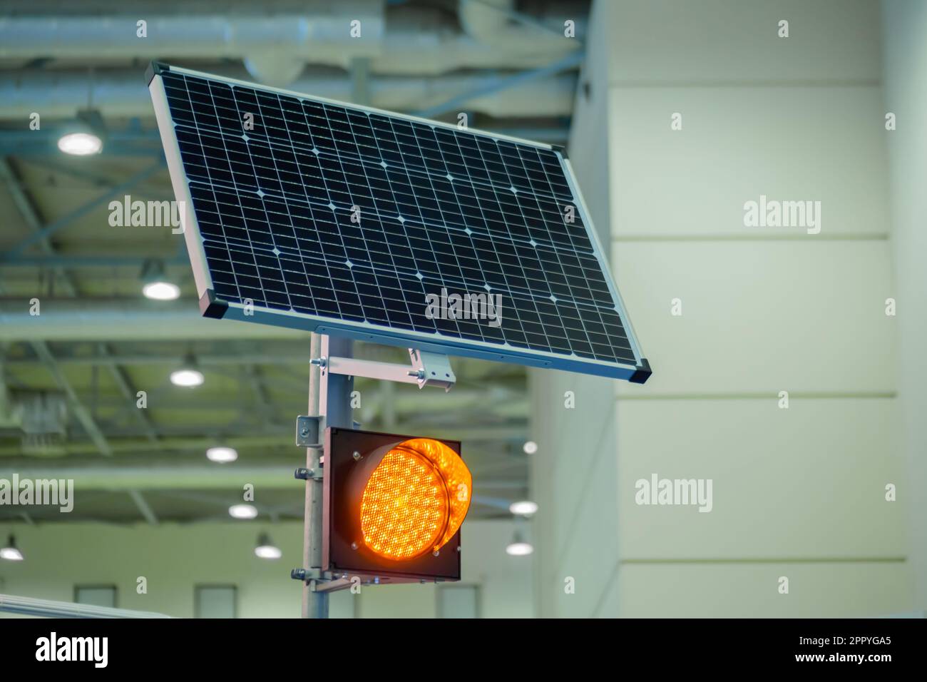 Single LED orange traffic light powered by solar panels at exhibition ...