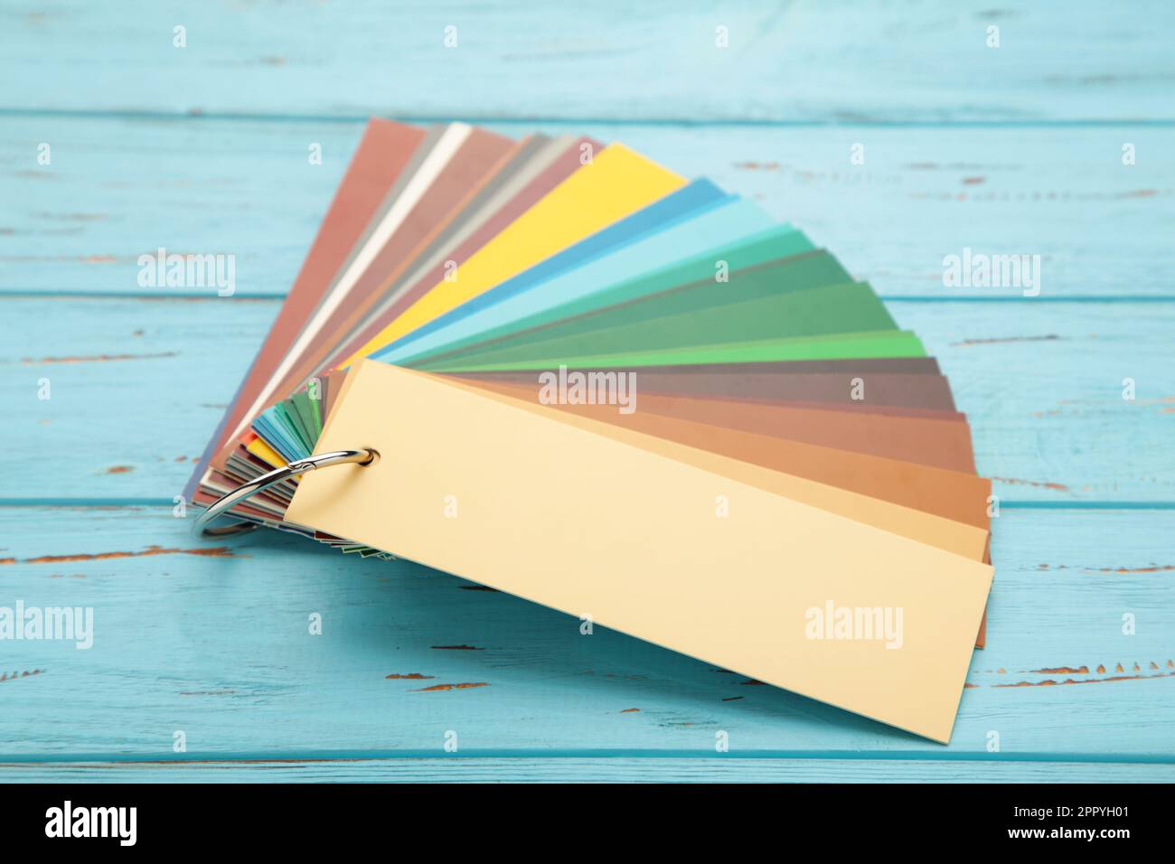 Colored cardboard palette, paper catalog on a blue wooden background ...