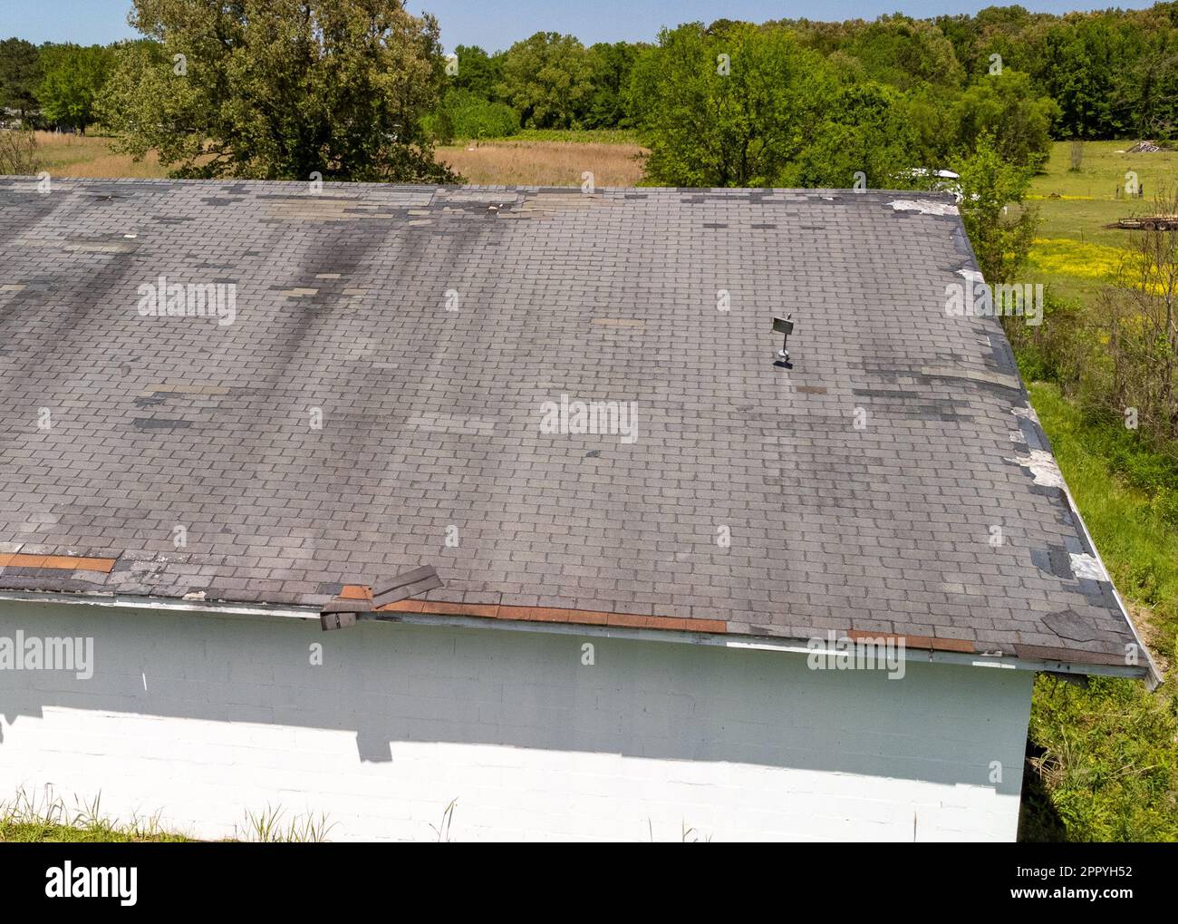 Roof missing shingles due to age, weather and storm damage Stock Photo ...