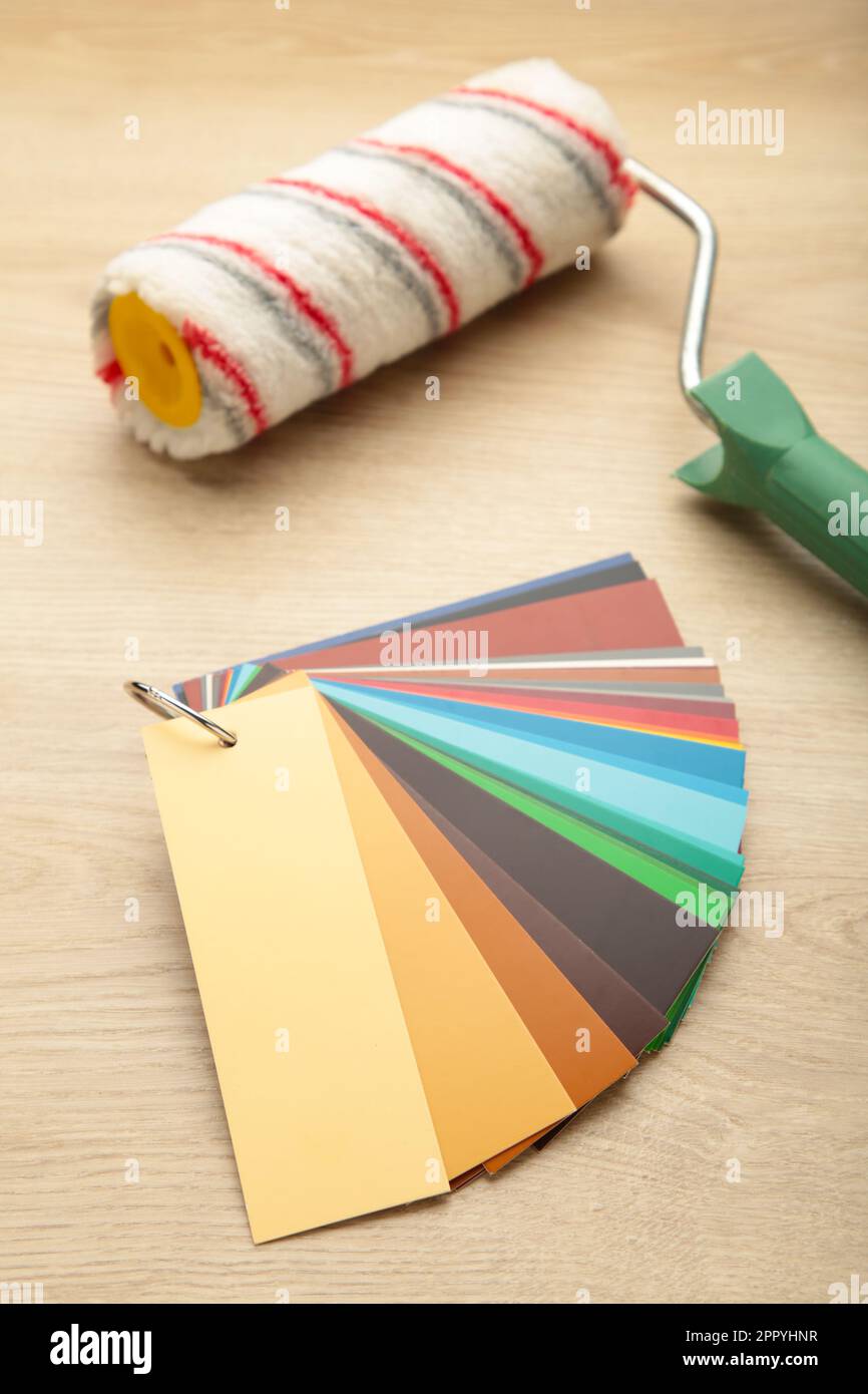 Coloured swatches and paint roller on table. Top view Stock Photo - Alamy