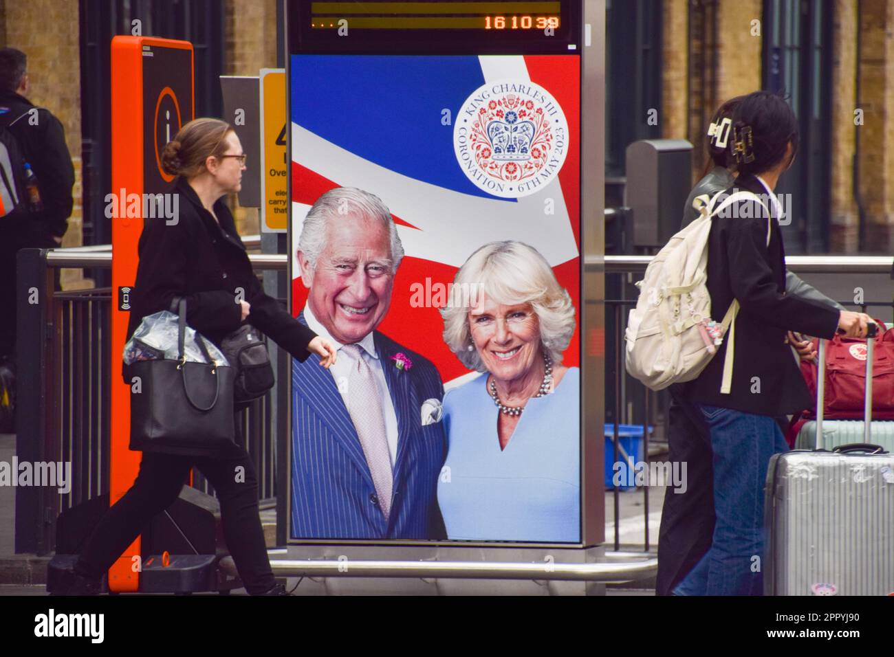 London, England, UK. 25th Apr, 2023. Commuters walk past a sign at a ...
