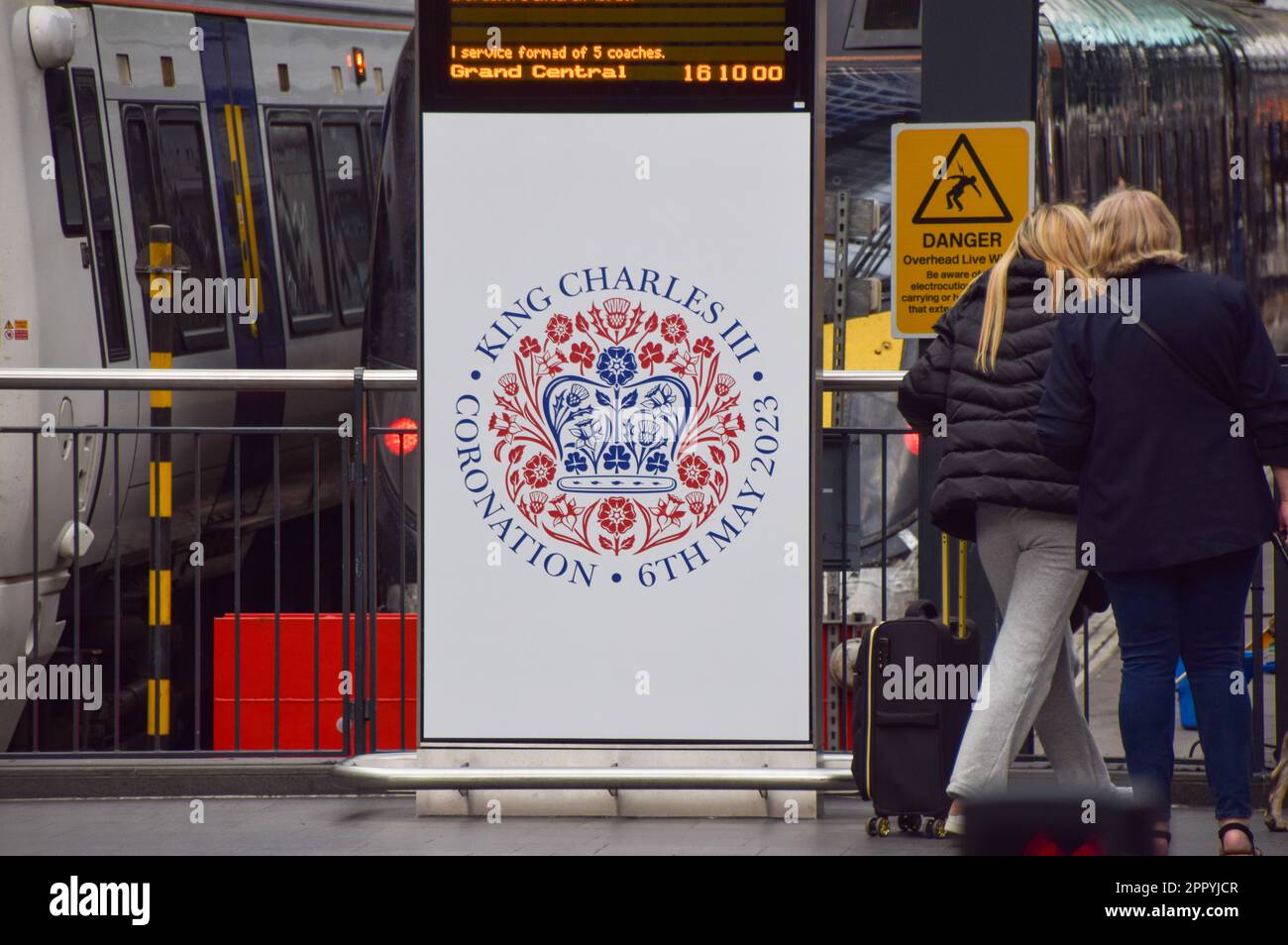 London, England, UK. 25th Apr, 2023. Commuters walk past a sign at a ...