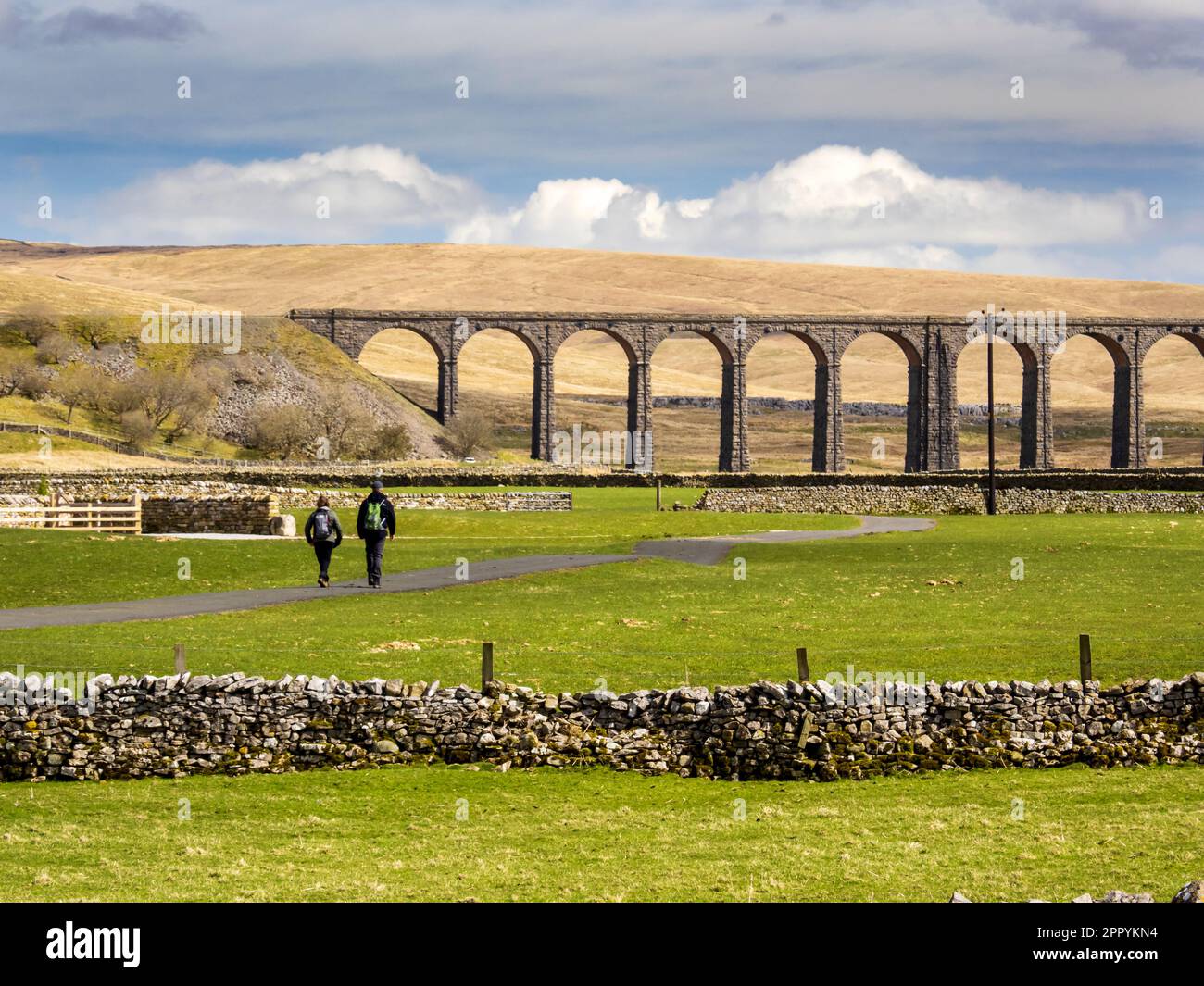 Hikers walking towards the iconic Ribblehead viaduct on the Settle ...
