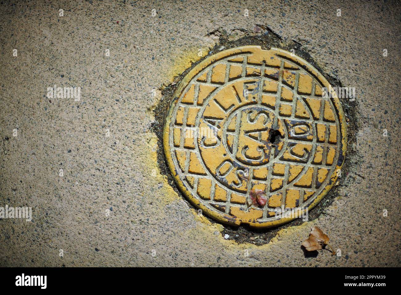 Yellow SoCal Gas pavement cover in the road in Costa Mesa, California ...