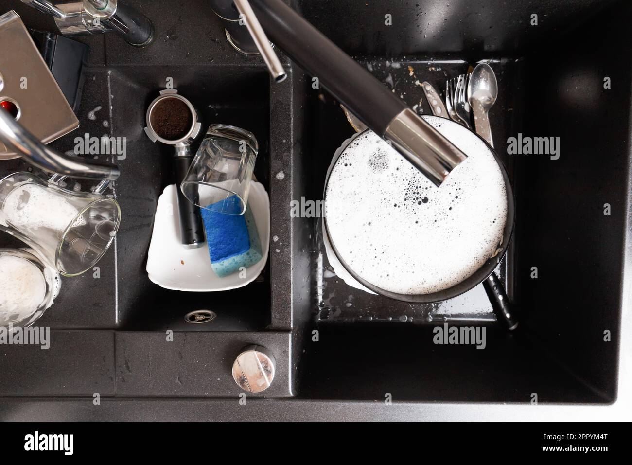 Washing dishes concept. Dirty dishes with foam from detergent in a ...