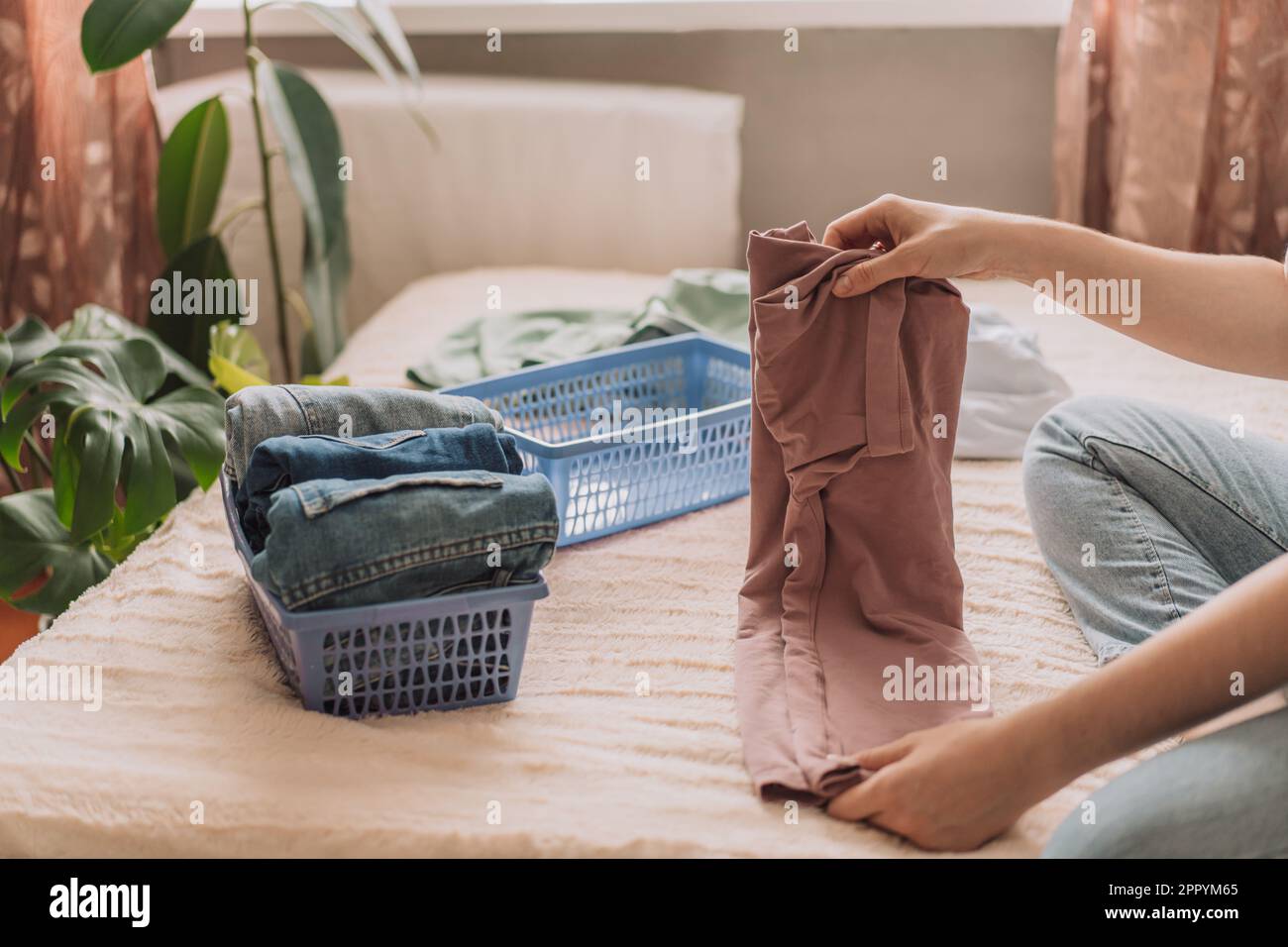 Woman folds clothes after washing hi-res stock photography and images ...