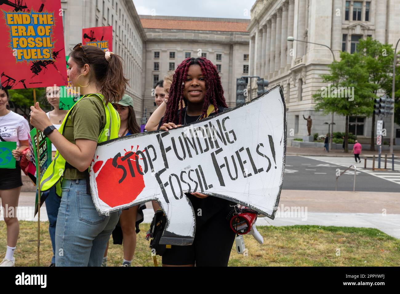 A female holding a Stop Funding Fossil Fuels! sign at the Earth Day March Stock Photo - Alamy