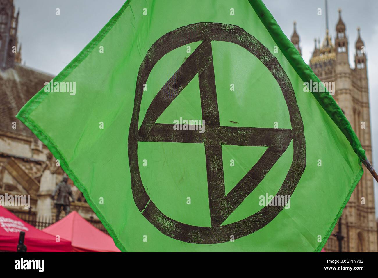 Green Extinction Rebellion flag seen outside the Houses of Parliament ...