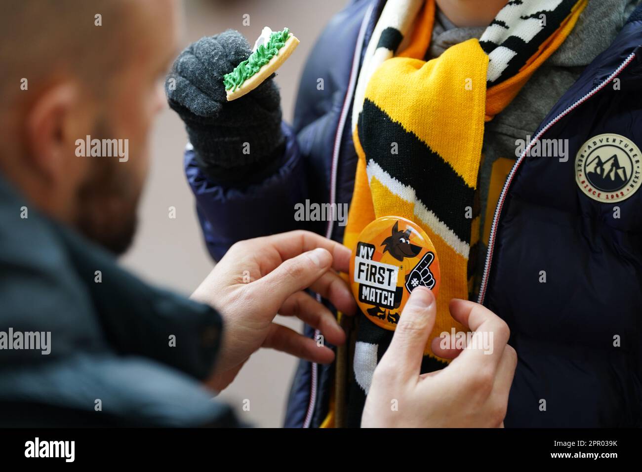 A Wolves fan attaches a badge to a scarf before the Premier League ...