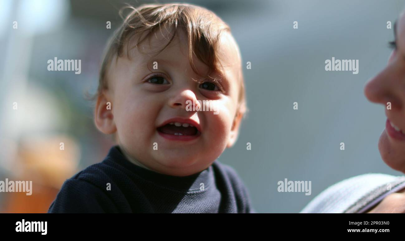 Cute bashful baby hiding face with hands Stock Photo - Alamy