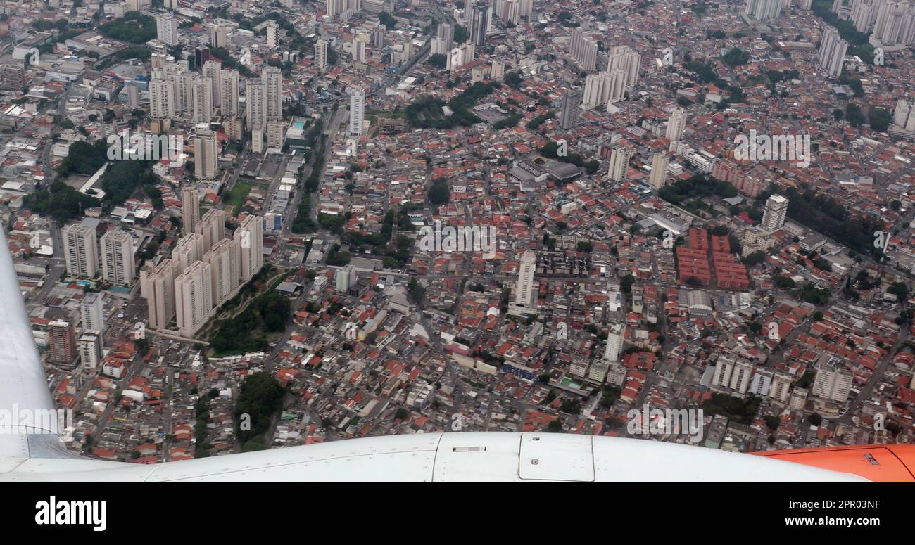 Flying over metropolitan large city of sao paulo, passenger looking ...