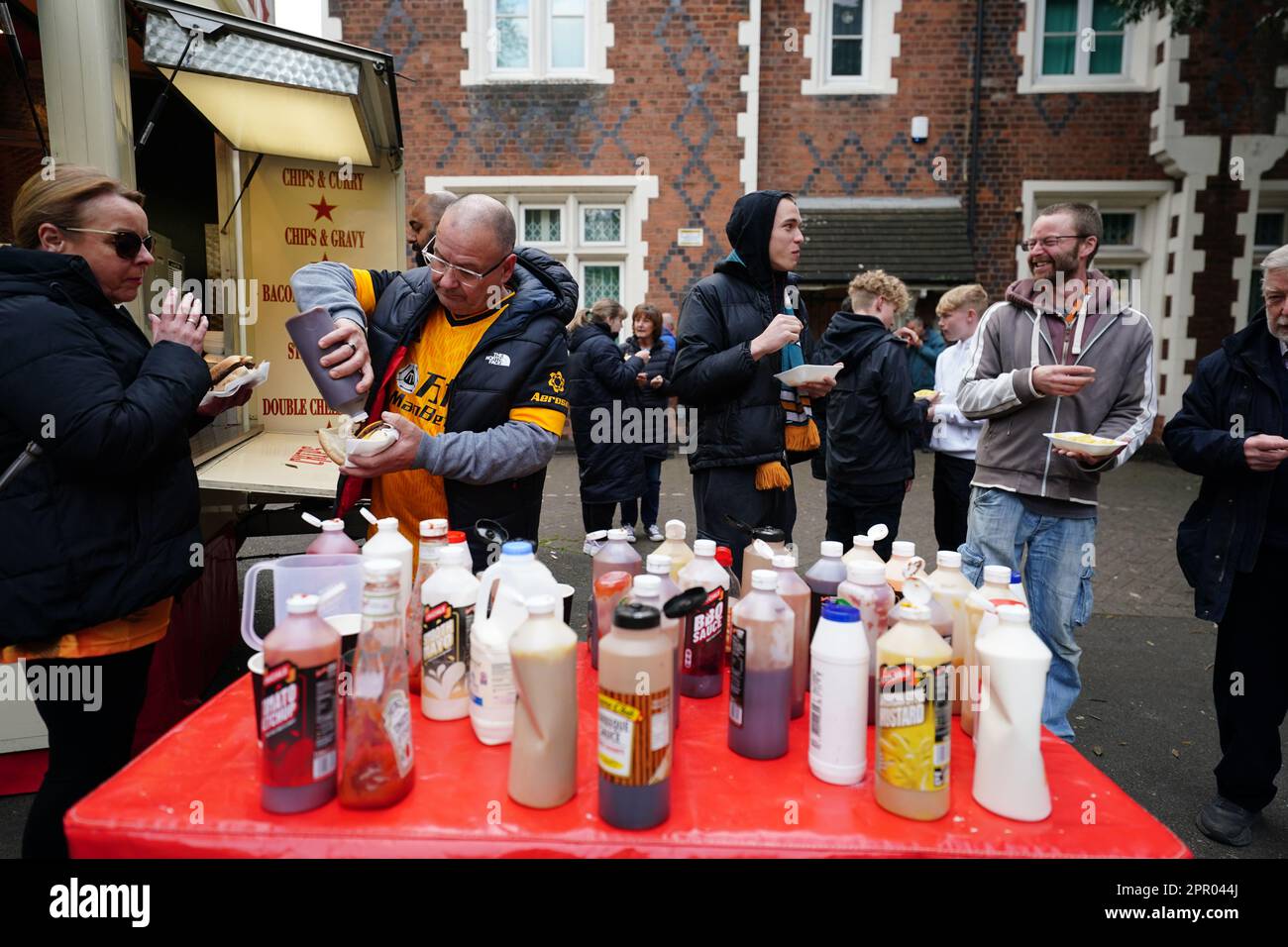Fans queue pick up condiments for their fast food before the Premier ...