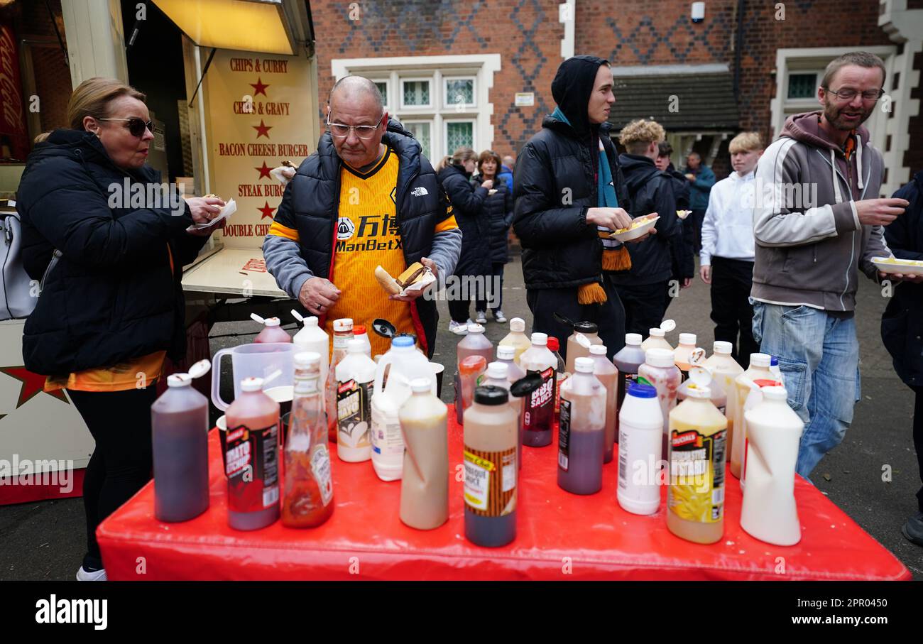 Fans queue pick up condiments for their fast food before the Premier ...