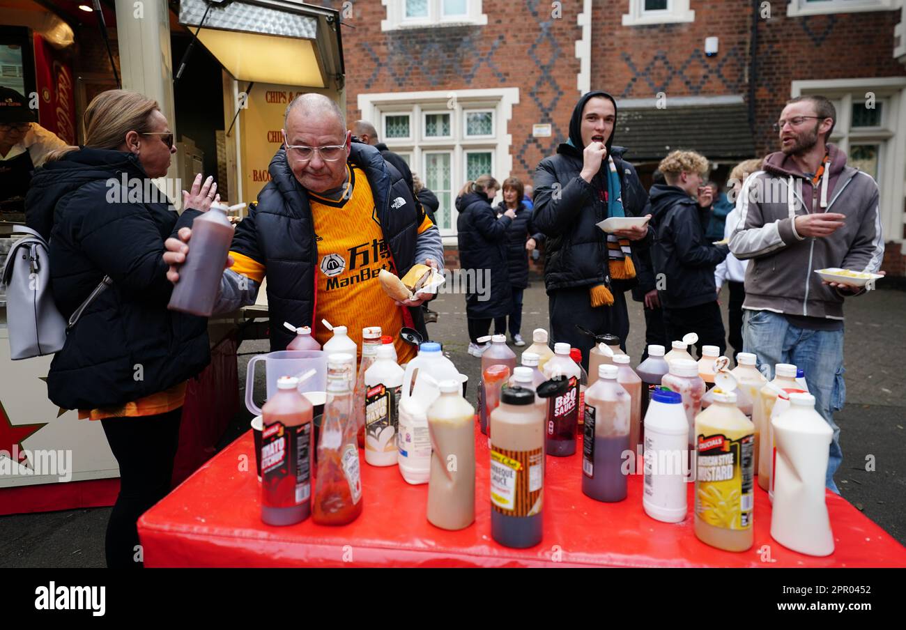 Fans queue pick up condiments for their fast food before the Premier ...
