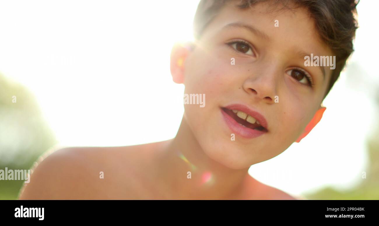 Handsome child boy outdoors with sunlight lens-flare. Kid in outside ...