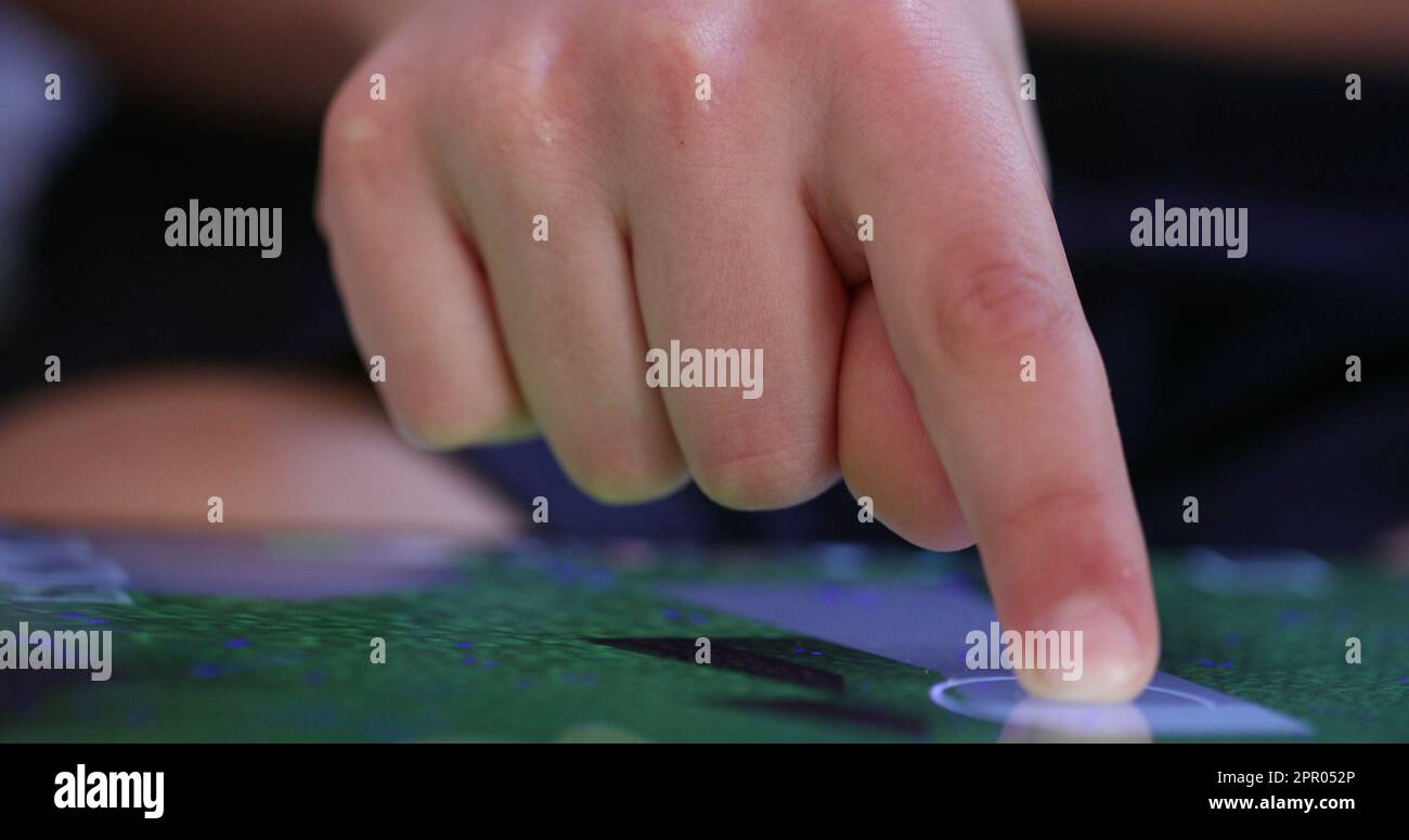 Child hand touching screen on tablet device Stock Photo - Alamy