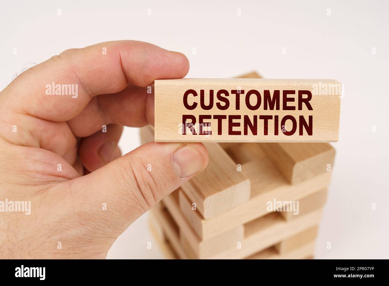 Business concept. A man holds in his hands a wooden block with the ...
