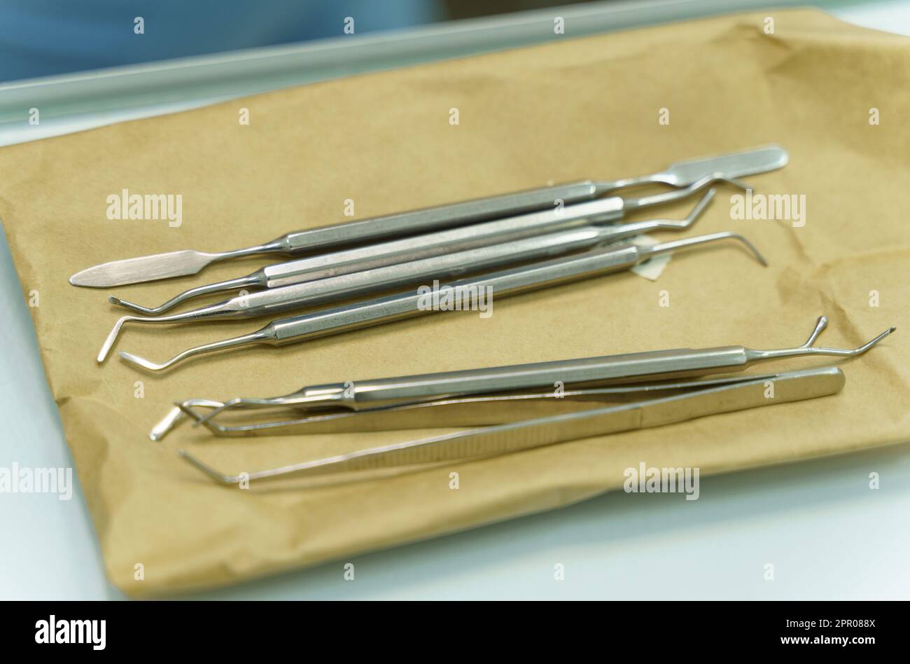 Dental instruments lie on wrapping paper before use. Close-up Stock ...