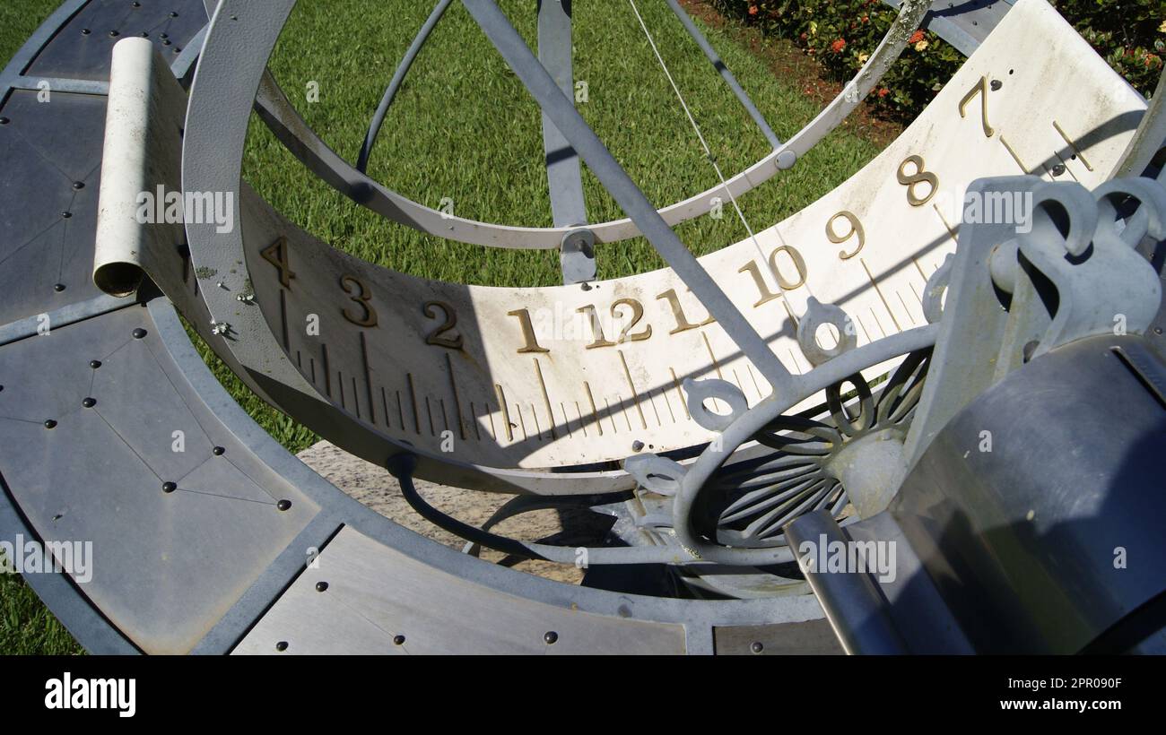 Sundial built in grassy garden showing numbers. Photo zoom with ...