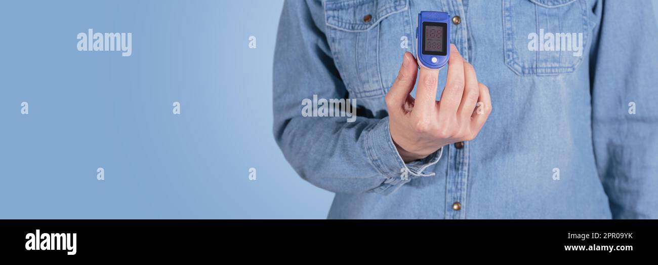 Woman self testing for blood oxygen levels from pulse oximeter Stock ...
