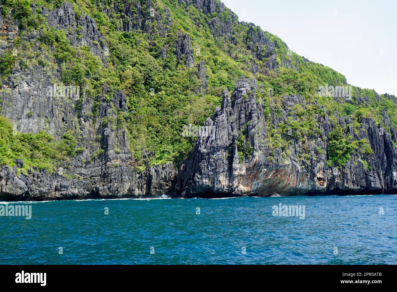 massive limestone rocks in the blue sea at the el nido archipelago ...