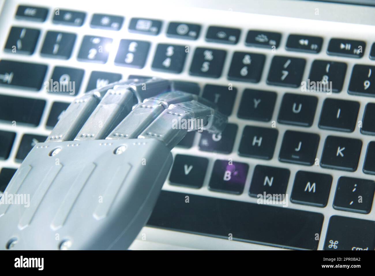 Robot hand while working on a computer keyboard Stock Photo - Alamy