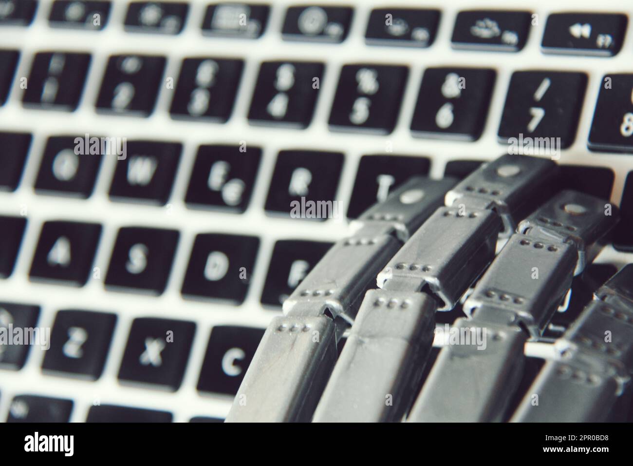 Hand of a robot while operating on a computer keyboard , space for text ...