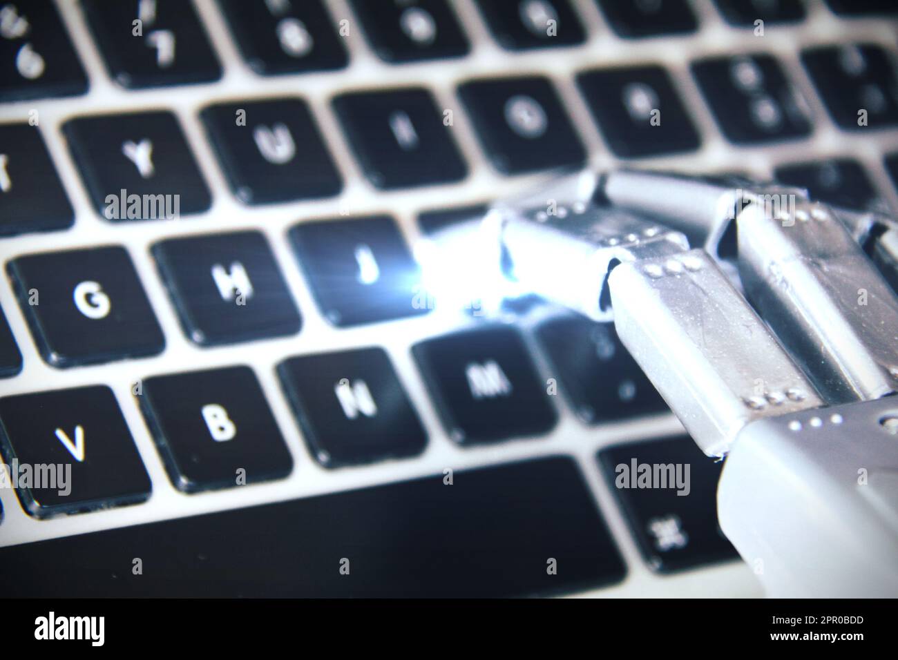 Robot hand working on a computer keyboard Stock Photo - Alamy