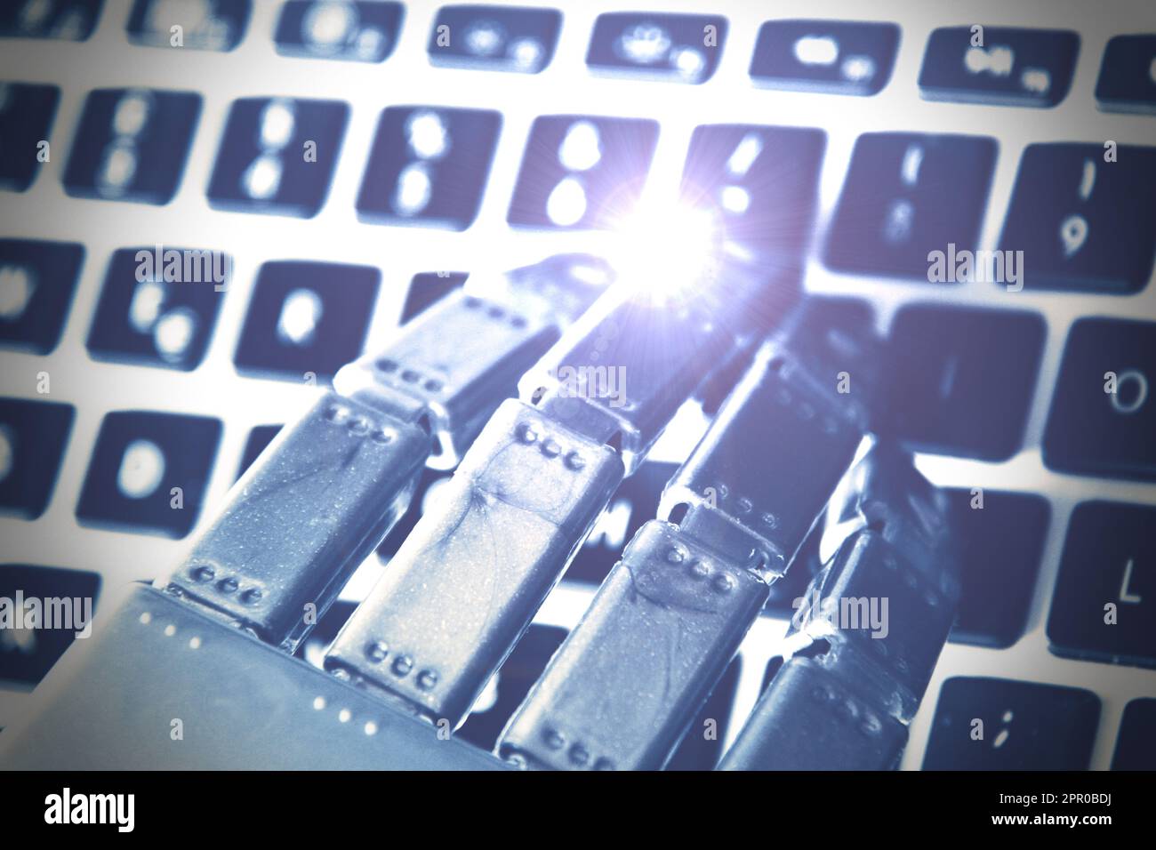 Hand of a robot while working on computer keyboard Stock Photo - Alamy
